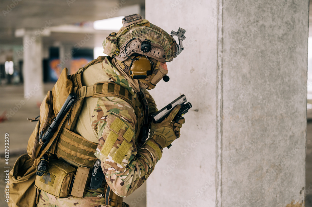 Special forces operator wearing Multicam uniform and his handgun xdm ...