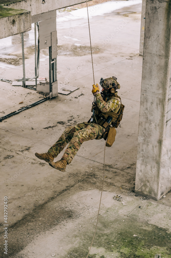 Special forces operator rappeling down the abandoned building on the ...