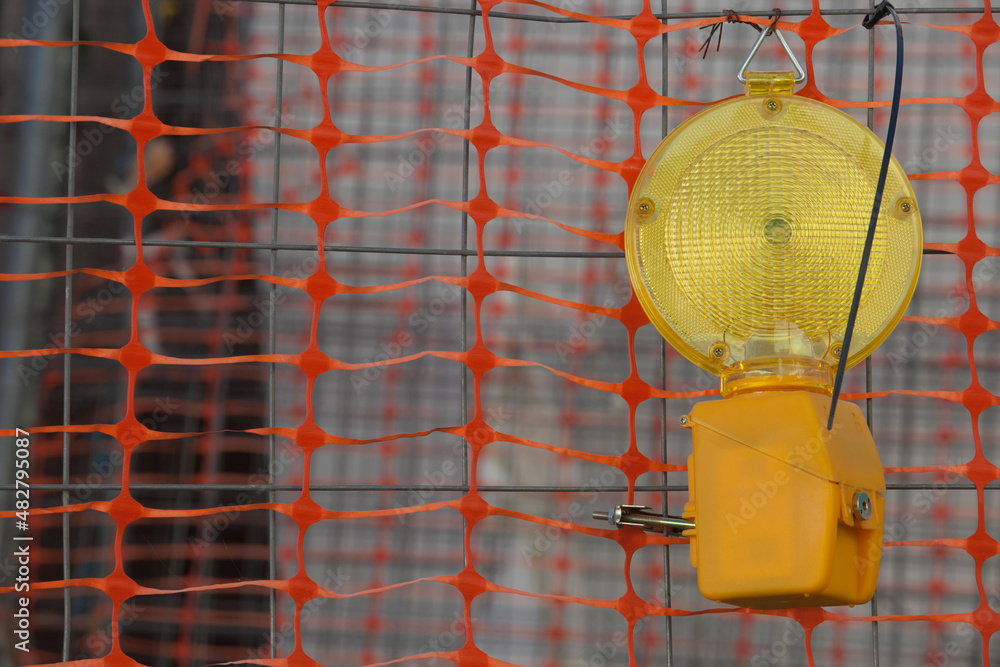 Emergency Flashing LED hanging on welded Wire. Construction site ...
