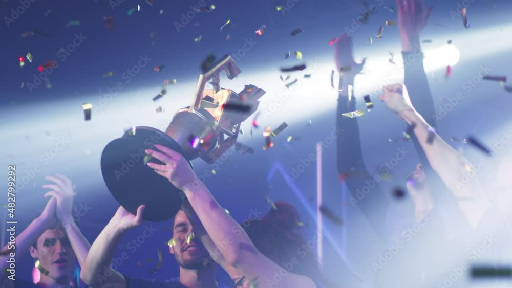 Excited gamer woman professional esportsman winner raising golden cup ...