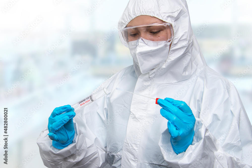 Medical healthcare NHS technician holding,COVID-19 swab collection kit ...