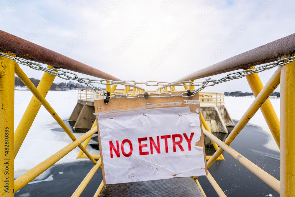No entry sign on chain in front of yellow metallic bridge Stock Photo ...