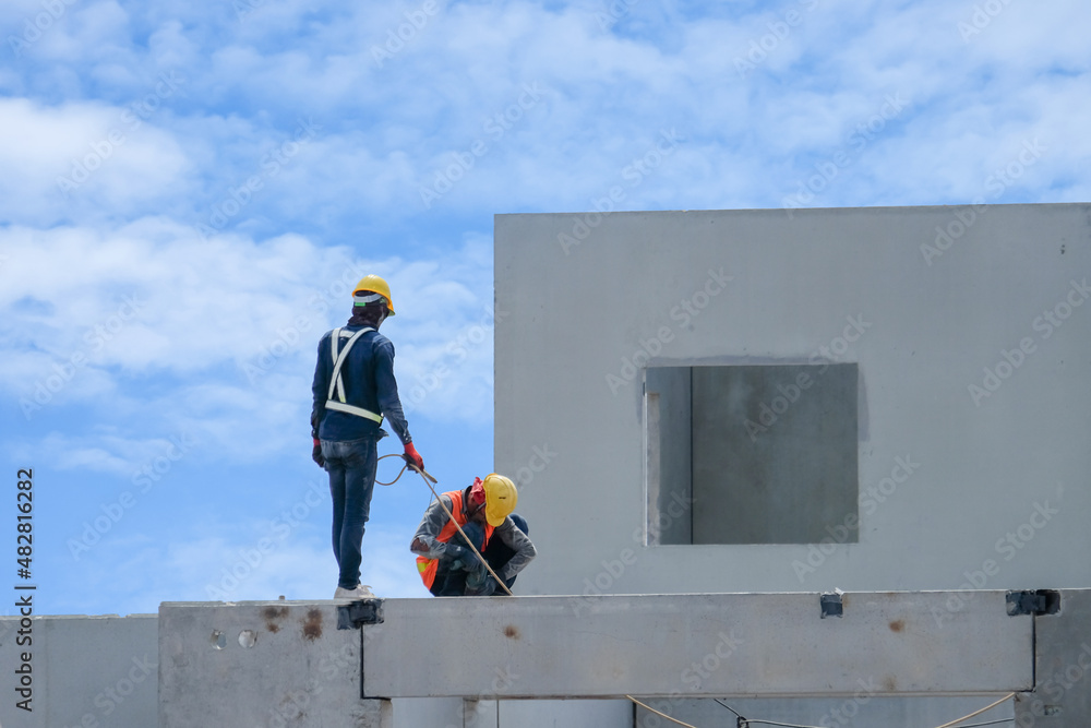 Construction worker are installing the precast concrete beam at housing ...