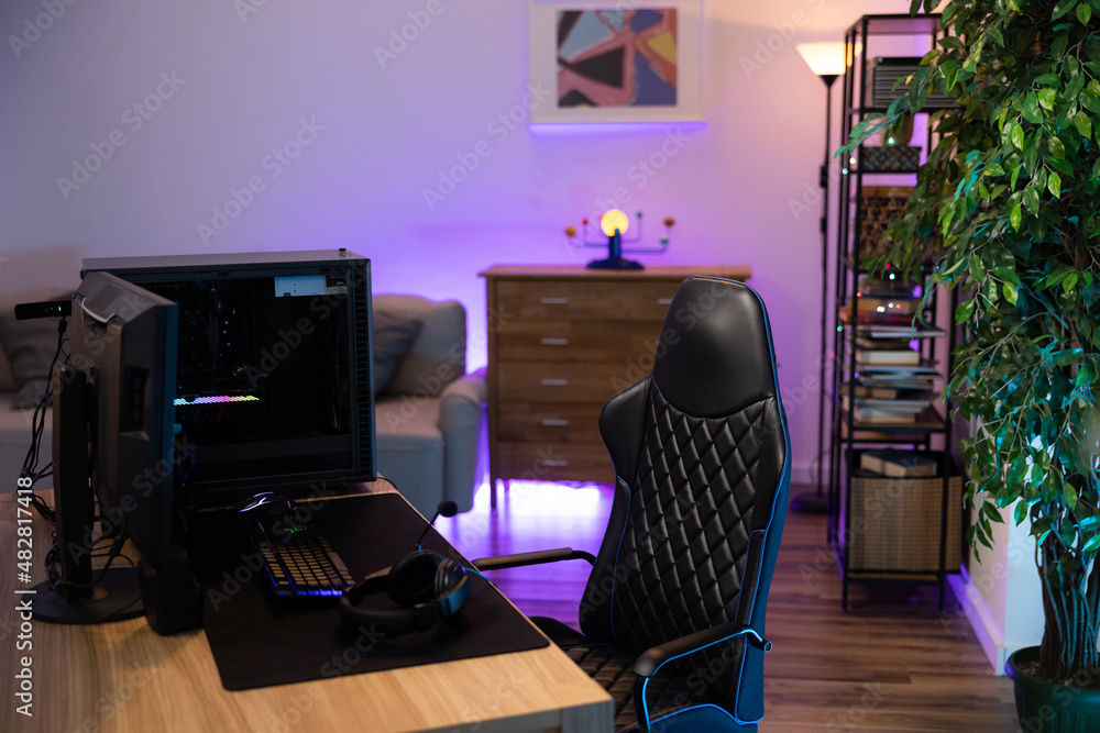 A backlit professional computer for a gamer. The monitor stands on a ...