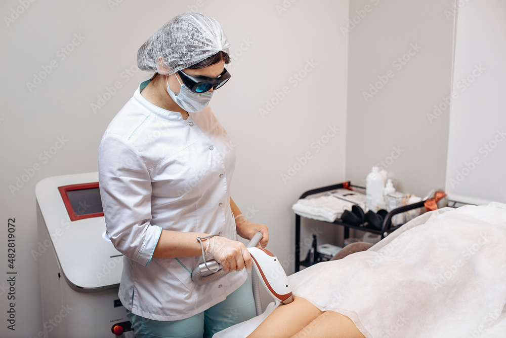 Hardware hair removal without shaving. The cosmetologist conducts a ...