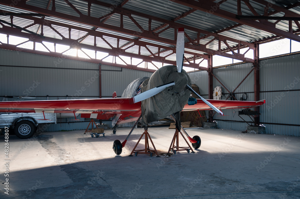 Small private lightweight propeller airplanes in hangar. Stock Photo ...
