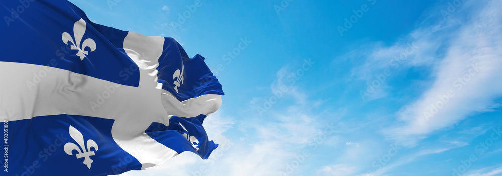 flag of Quebec , Canada at cloudy sky background on sunset, panoramic ...