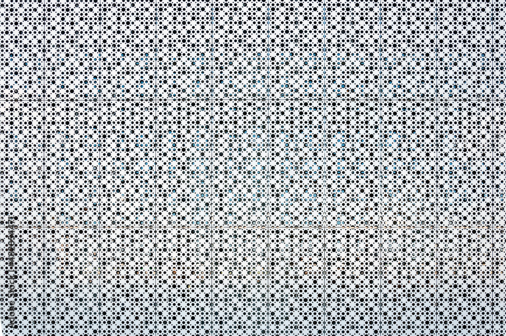 Grey perforated panels for facing the facade of the building. For ...