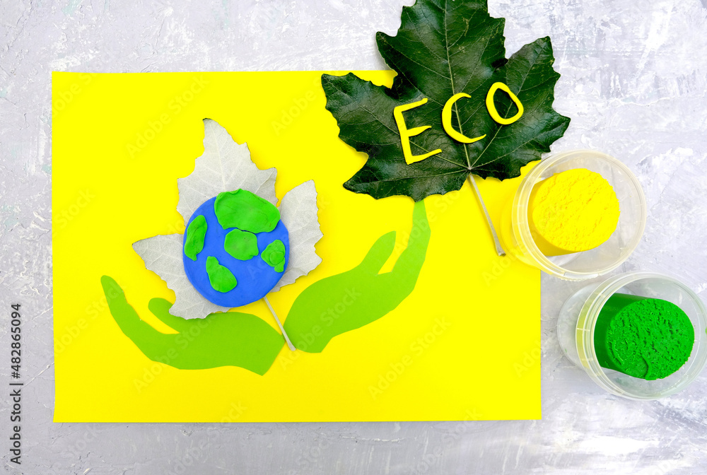 Child sculpturing plasticine planet for earth day. Protection of ...