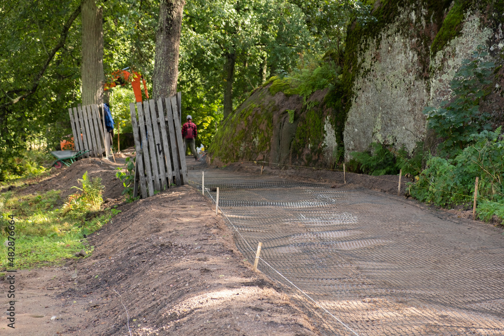 construction of a road in the forest among rocks, installation of a ...