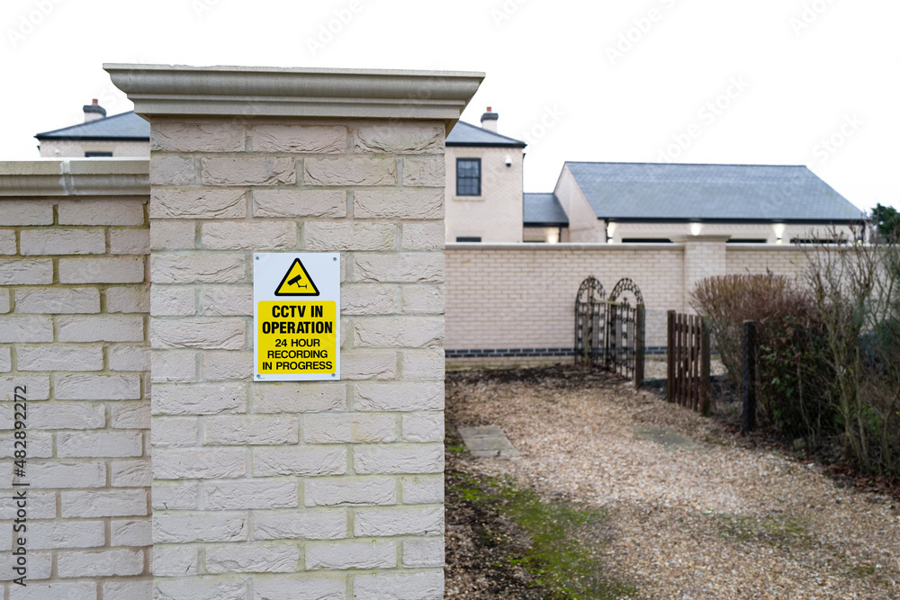 Newly installed CCTV Warning sign attached to a pillar outside a newly ...