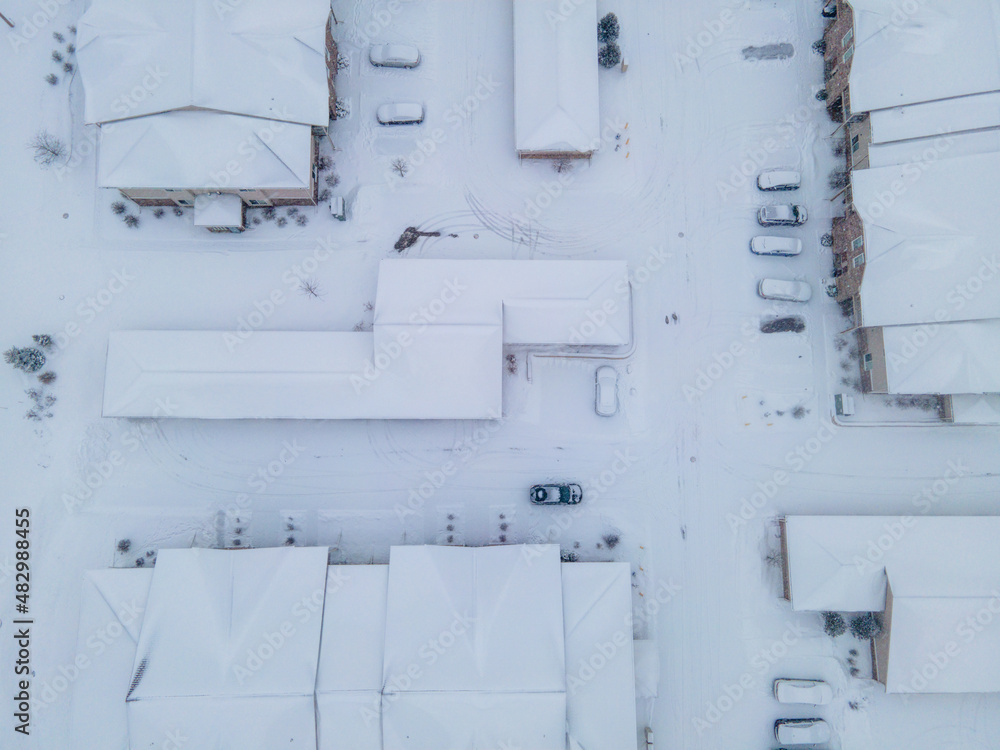 top down view over apartment buildings during a snow storm. Geometric ...