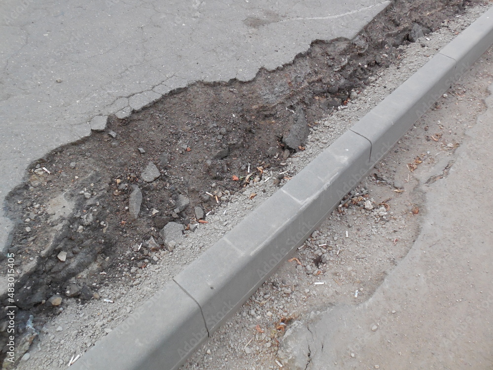 Repair and construction of road works. Installation of a concrete curb ...