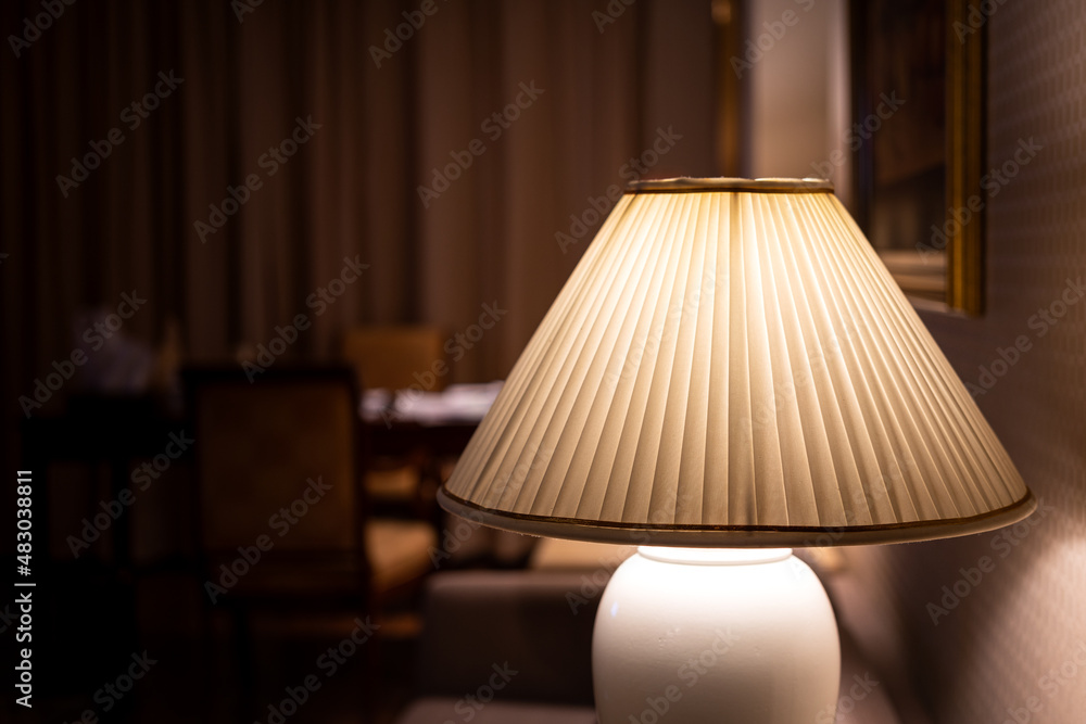 Turning-on classic style lighting lamp with working desk as background ...