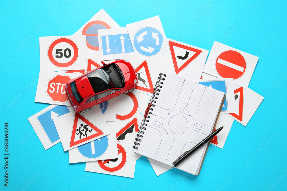 Many different road sign cards, notebook with sketch of roundabout and ...