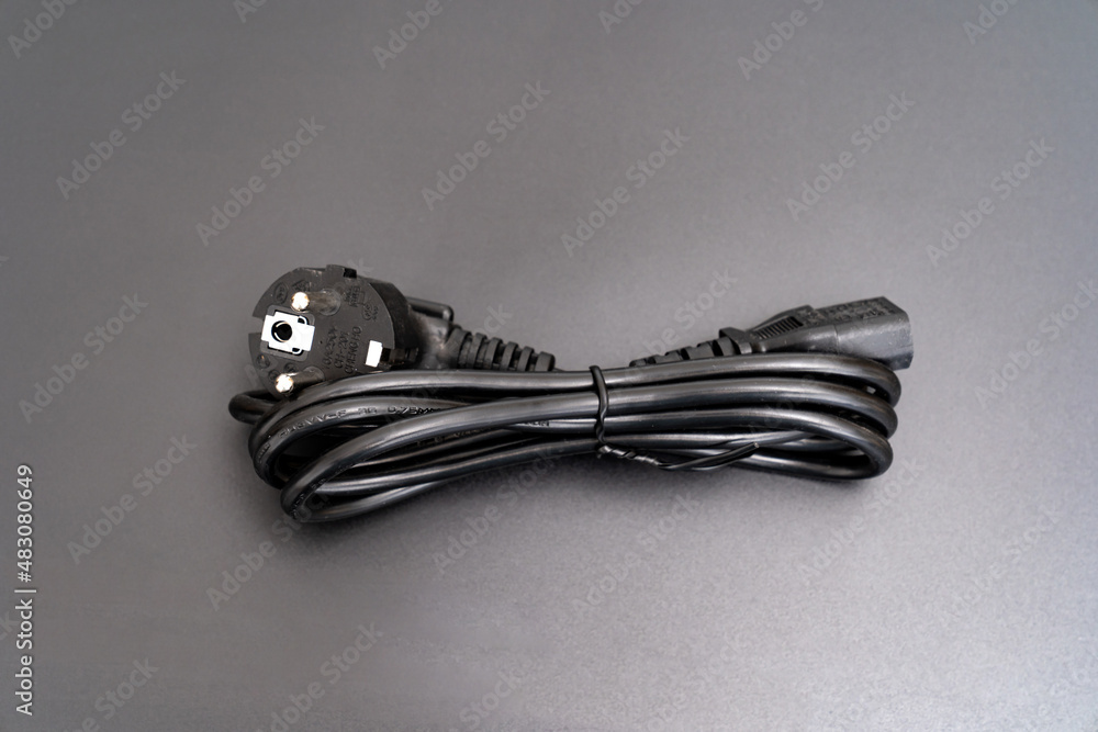 black power cable for PC, monitor, equipment on black background. a ...