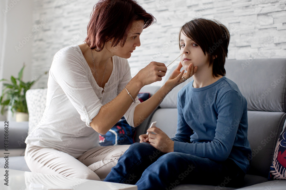 Mother, testing her child for covid 19 at home, making SWAB antigen ...