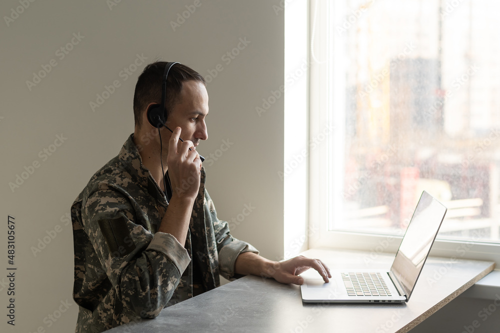 Soldier working with laptop in headquarters building Stock Photo ...