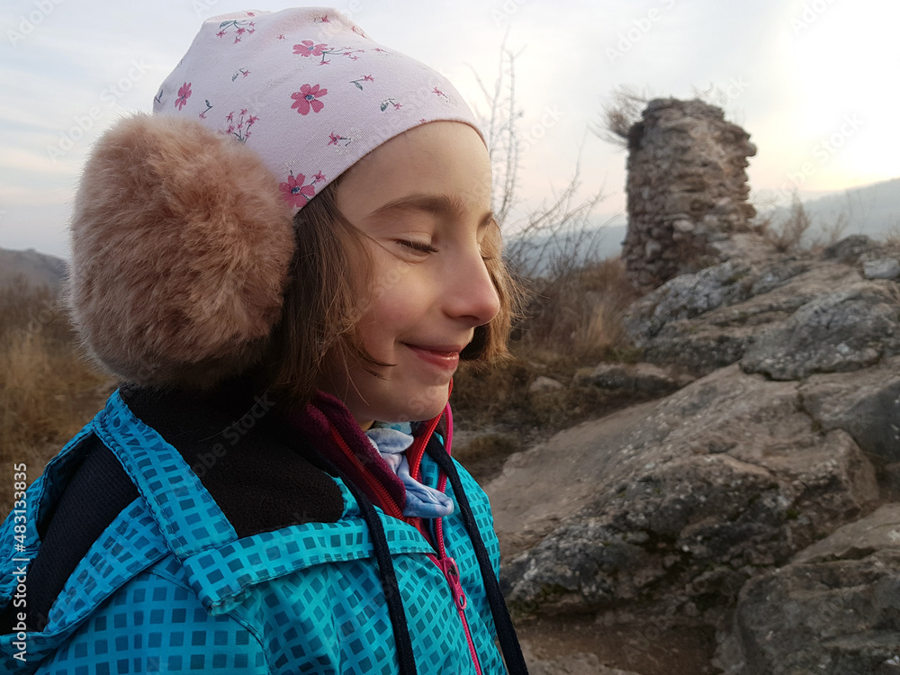 Cute young girl posing with winter ear cap in the outdoors Stock Photo ...