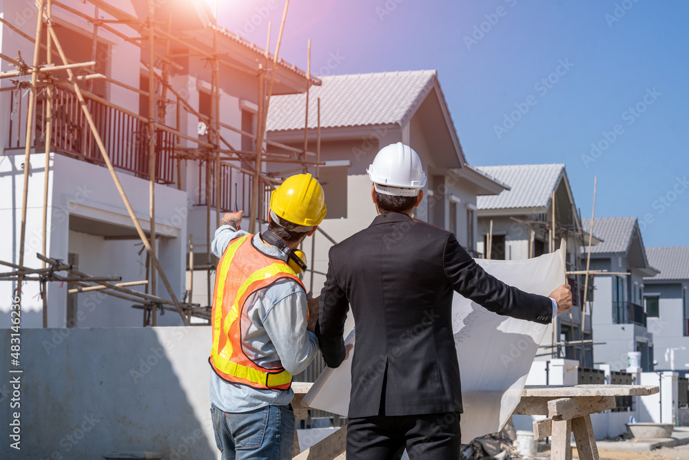 Architect concept,Architects and businessman working with blueprints at ...