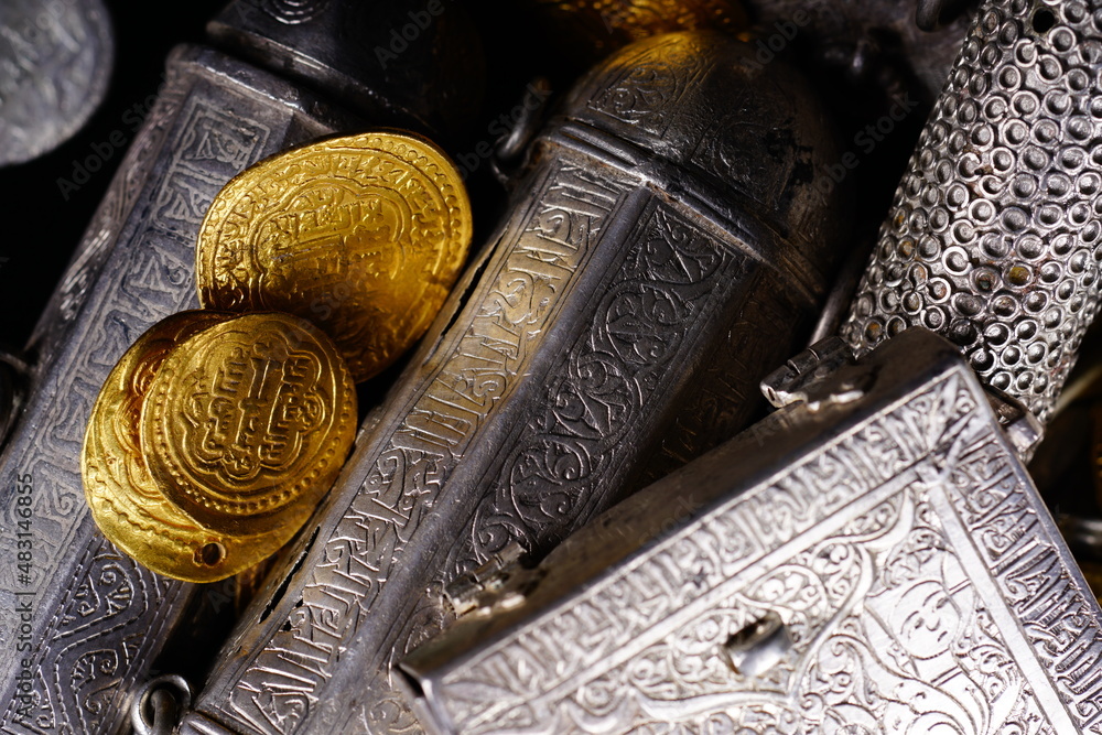 A lot of stacked gold bullion bars and gold coins and silver coins in a ...