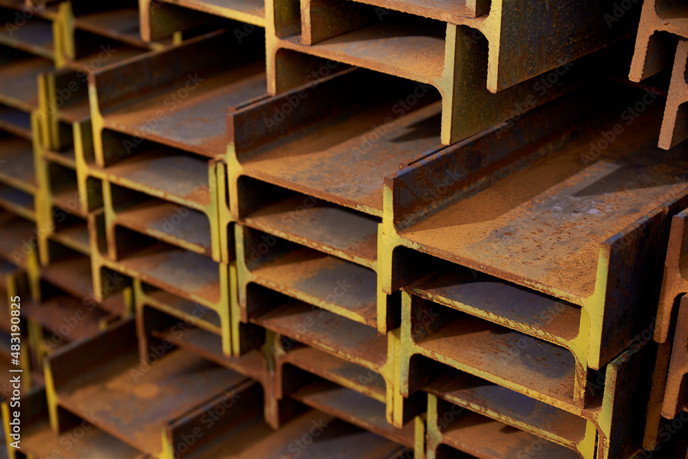Rolled metal beams are stored in a warehouse in packages Stock Photo ...