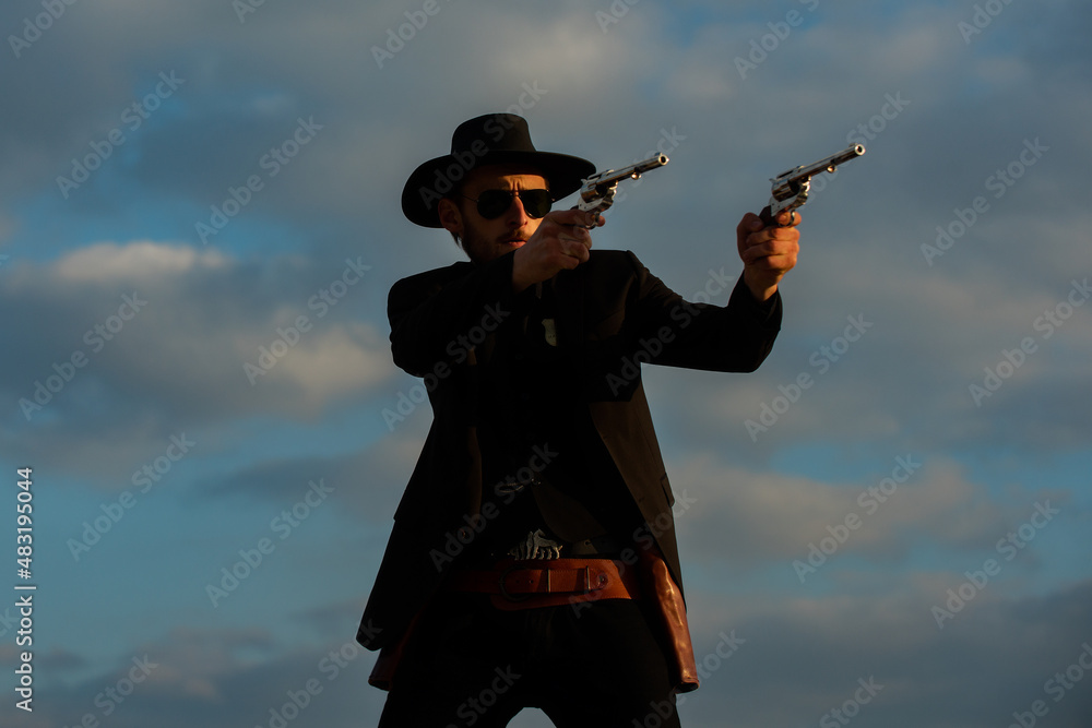 Cowboy shooting. Sheriff officer in black suit and cowboy hat. Man with ...