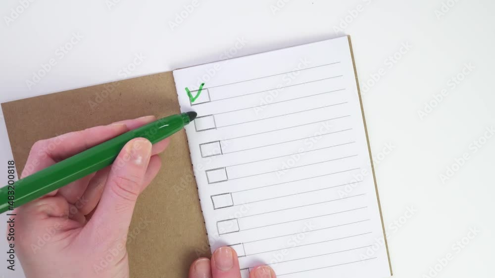 Done and green tick. flat lay to do list write in a notebook. male left ...
