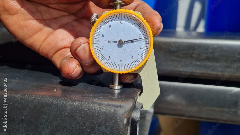 measuring the thickness of iron with a thickness gauge or sketch Stock ...