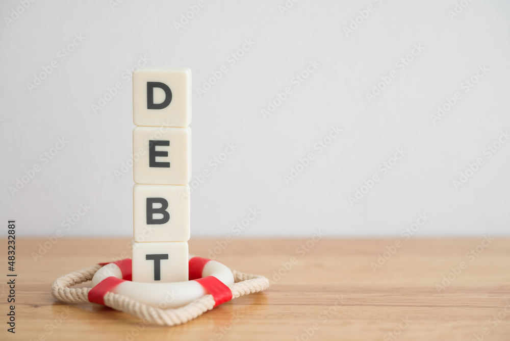 Debt protection insurance concept. Word DEBT is protected by lifebuoy ...