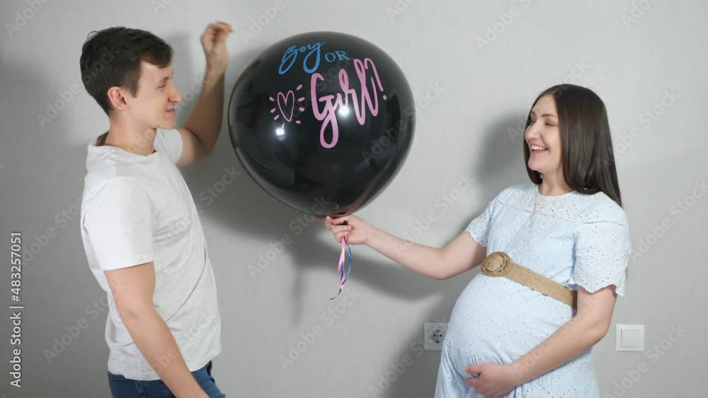 young parents find out the gender of their unborn child by popping a ...