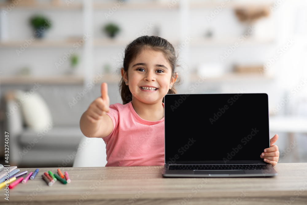 Little Girl Showing Laptop With Black Screen And Gesturing Thumb Up ...