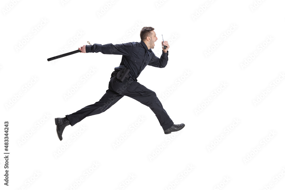 Dynamic portrait of young man, policeman officer wearing black uniform ...