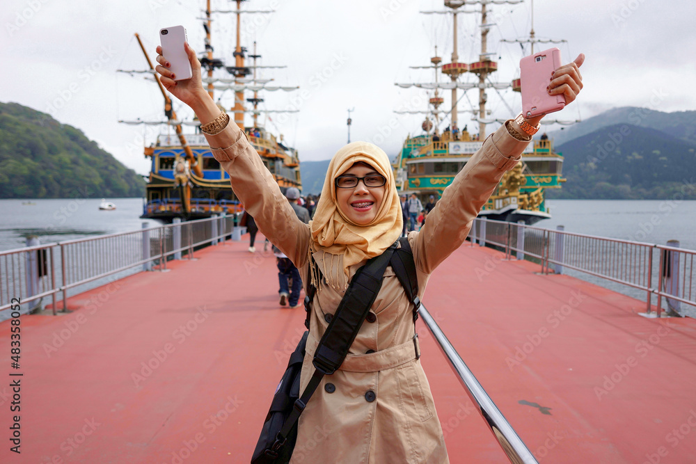 Portrait of smiling muslim woman on Togendai Station pier at Lake Ashi ...