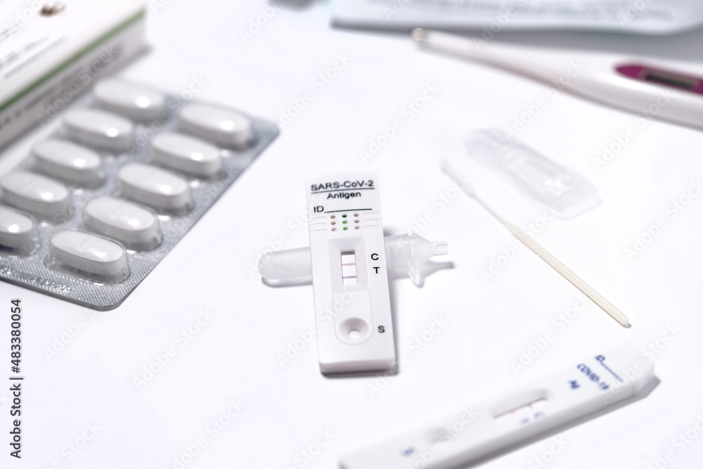 COVID-19 rapid antigen test positive result, thermometer and ...