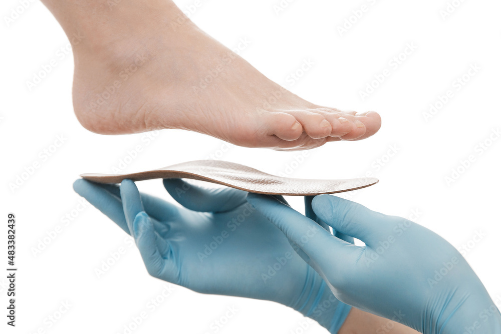 Orthopedic insole isolated on a white background. Hands in rubber ...
