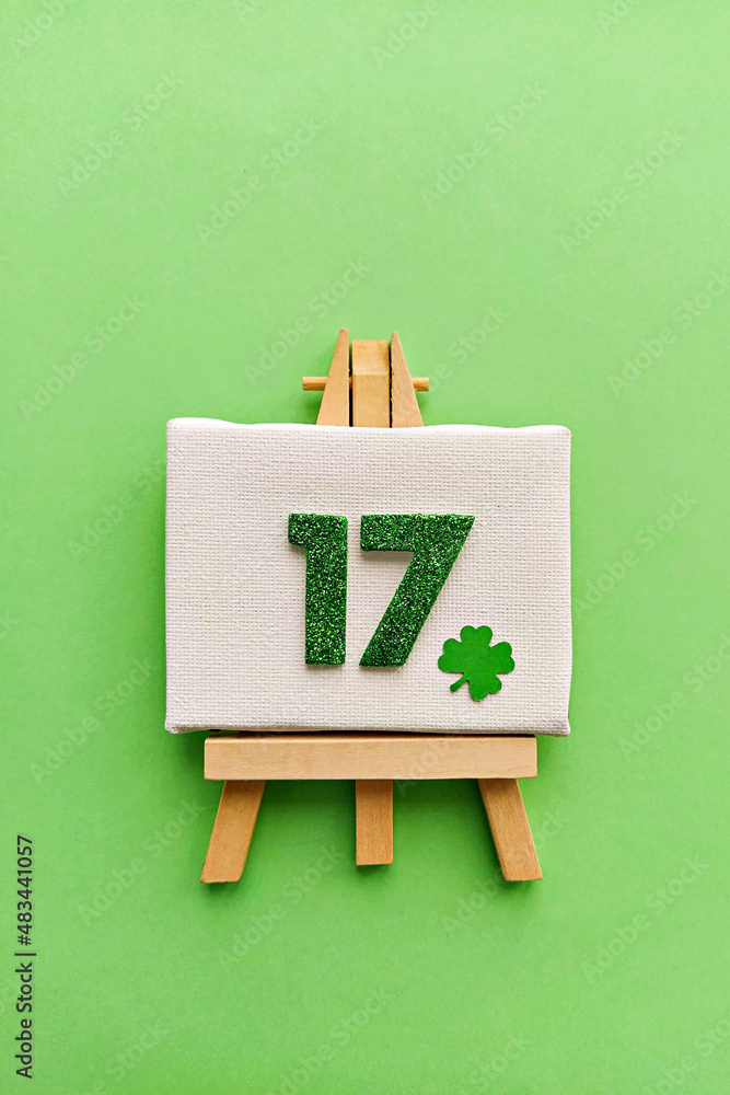 Miniature easel with canvas and green numbers 17 with four-leaf clover ...