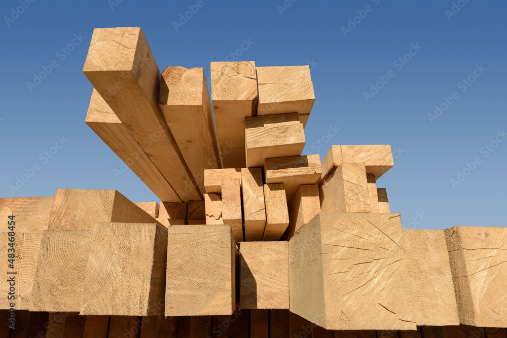 Wooden building materials. Stacked boards at a construction site ...