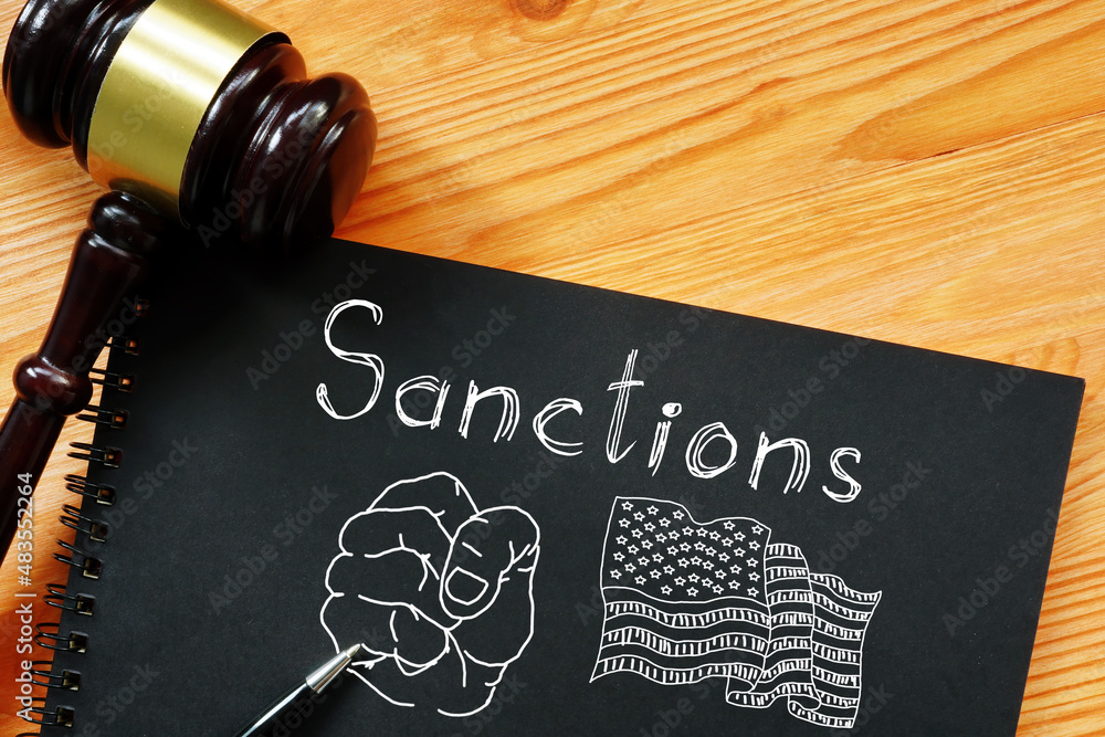 Sanctions are shown on the photo using the text Stock Photo | Adobe Stock