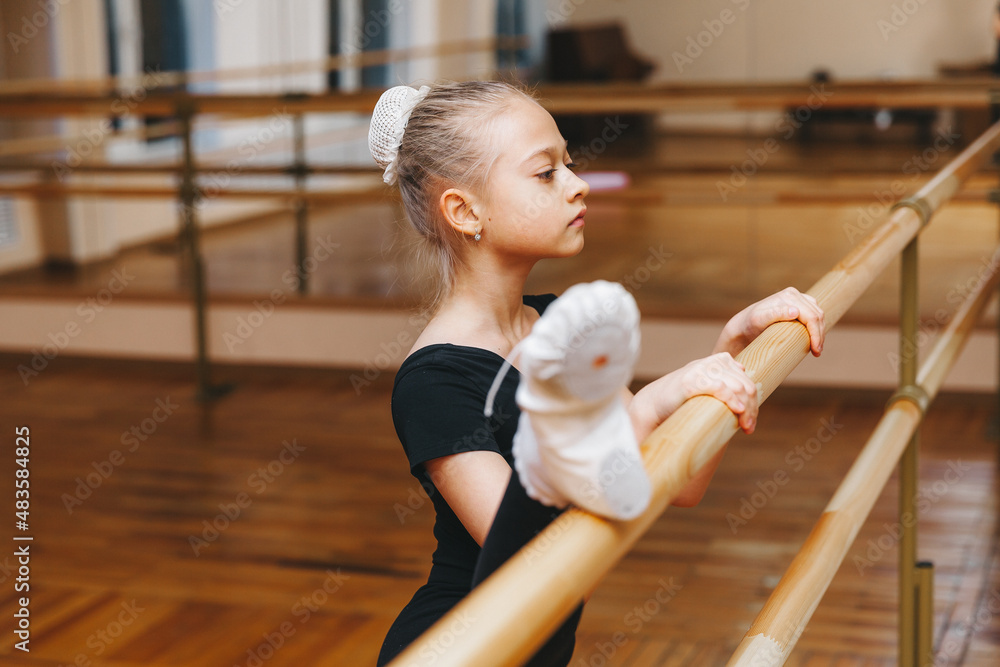 girl gymnast studio. little gymnast performs an exercise on the floor ...