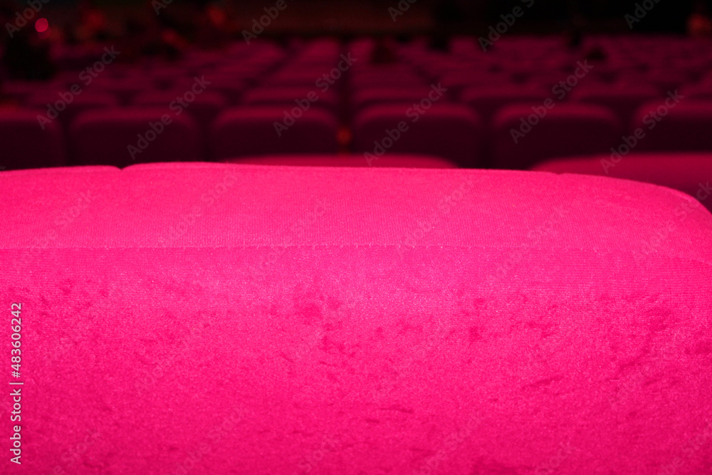 pink armchairs. Empty concert hall, theater chairs background ... color ...