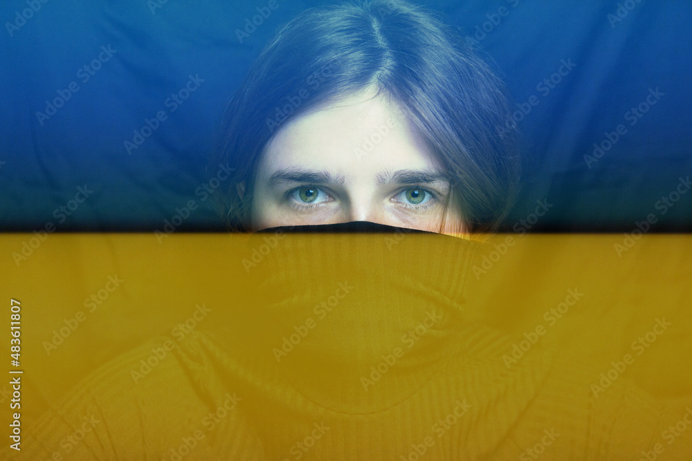 War between Russia and Ukraine. Young woman with sad sight looking at ...