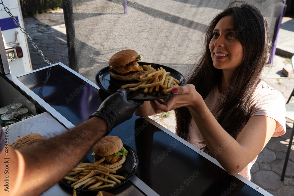 Food truck chef giving hamburger to customer Stock Photo | Adobe Stock
