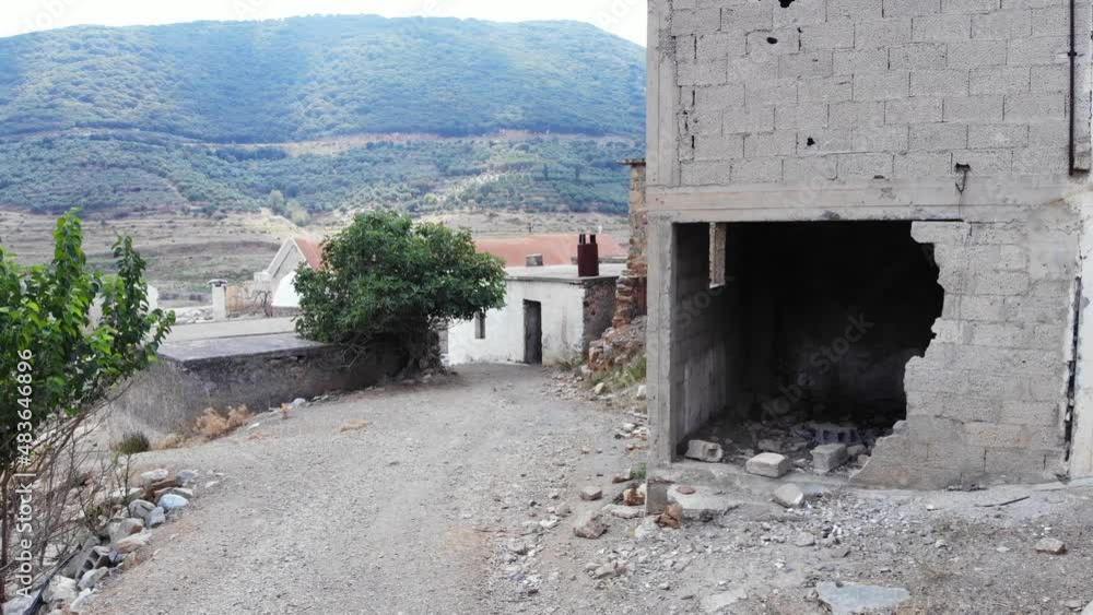 Camera move towards broken buildings, destructed houses of Sfendili ...