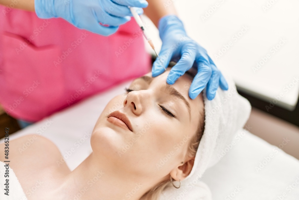 Doctor injecting botox on woman face for anti aging treatment at the ...