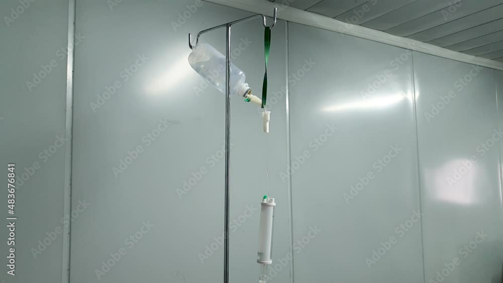 Hydration IV intravenous fluid drip with NaCI sodium chloride setup in ...