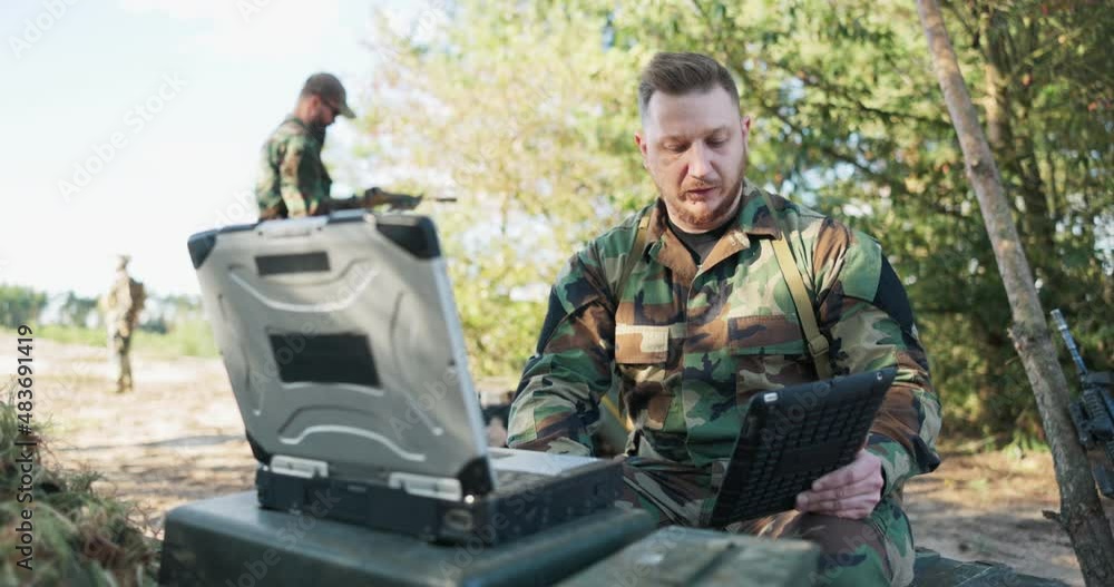Serious experienced army commander is in field having video ...