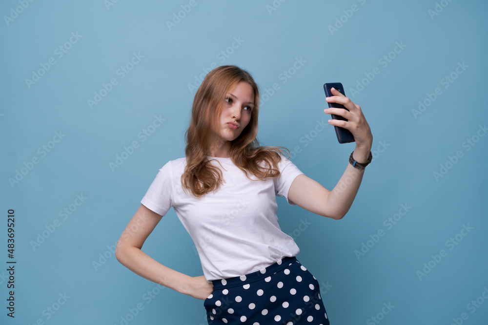 Young Female Vlogger With Surprised Face Takes Picture Herself On Phone