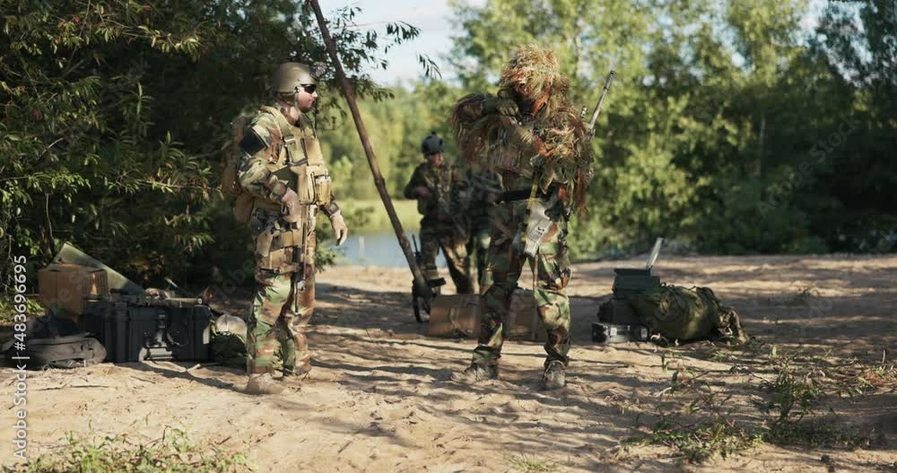 Troops dressed in uniform secure the area of the army base, men with ...