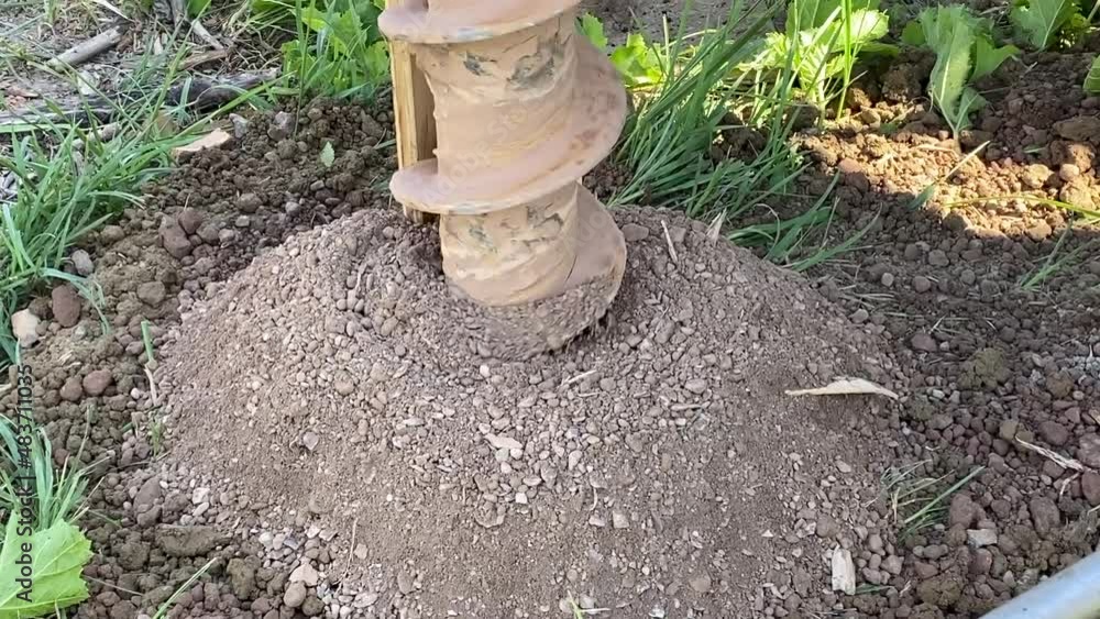 Sampling of Soil by Drilling. A geological drill digs into the ground ...